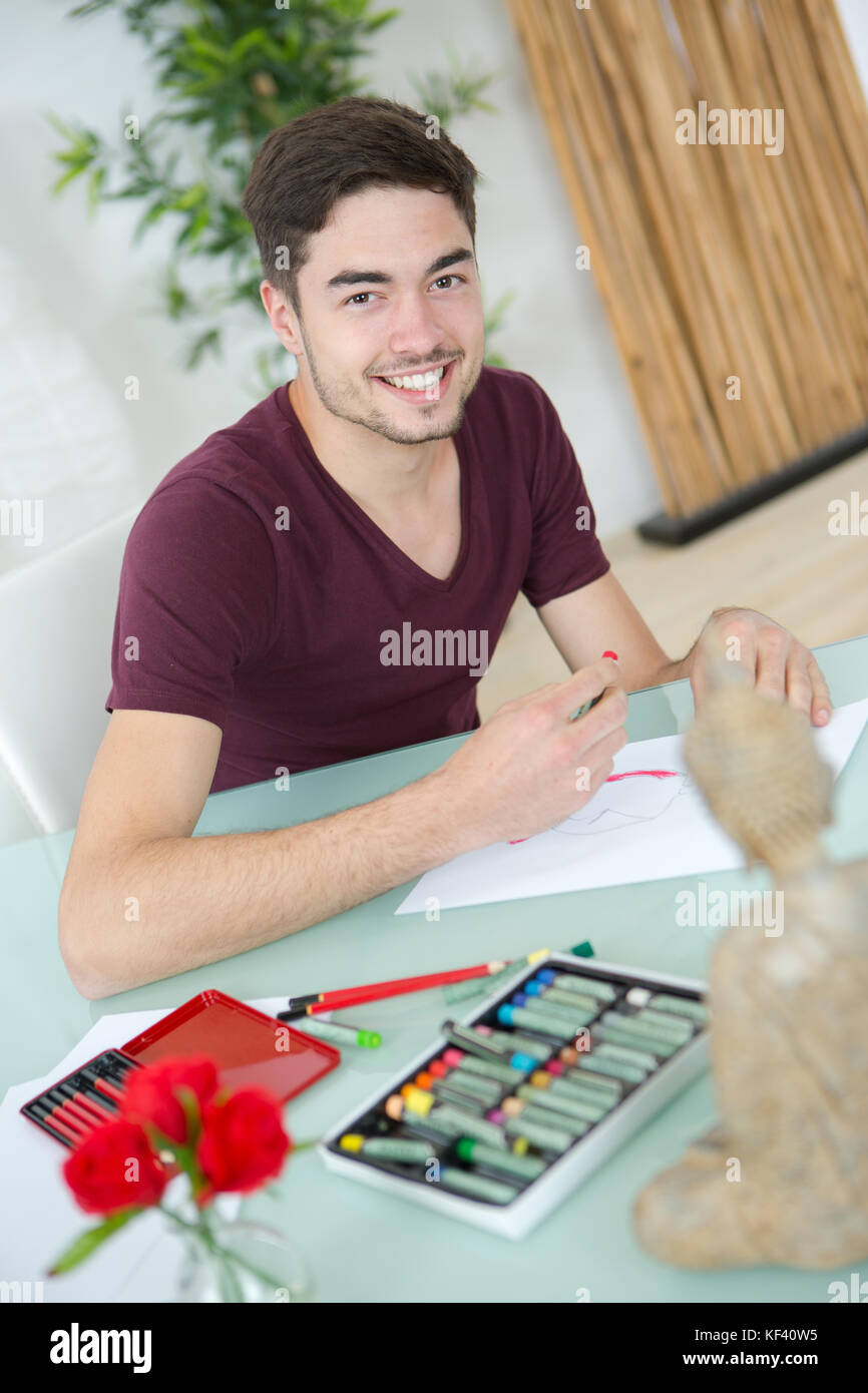young man drawing pictures in studio Stock Photo - Alamy