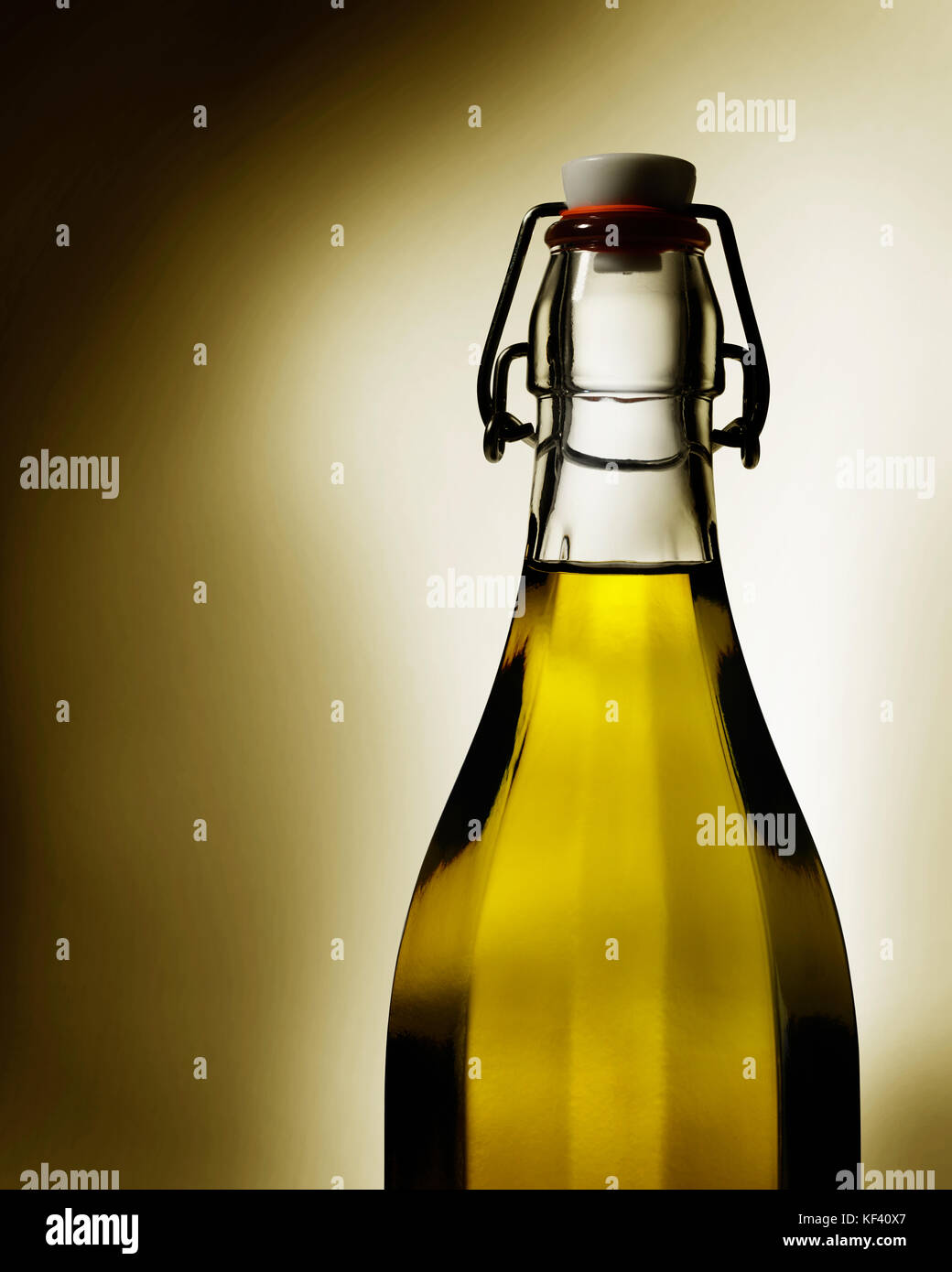 Dramatic light glows through olive oil in a clear glass bottle Stock ...