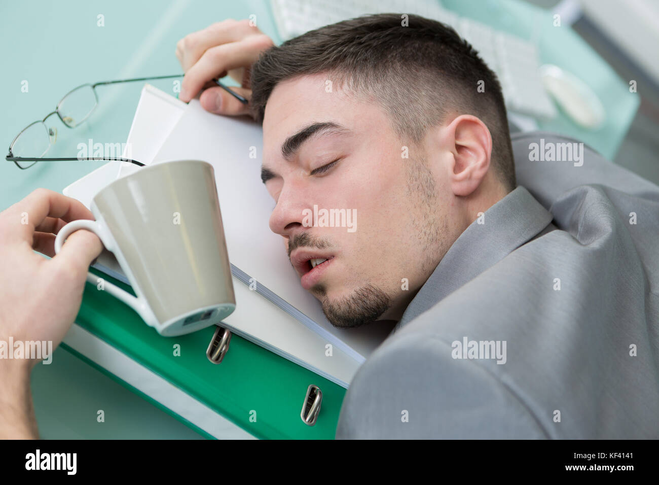 young man sleeping at his desk Stock Photo - Alamy