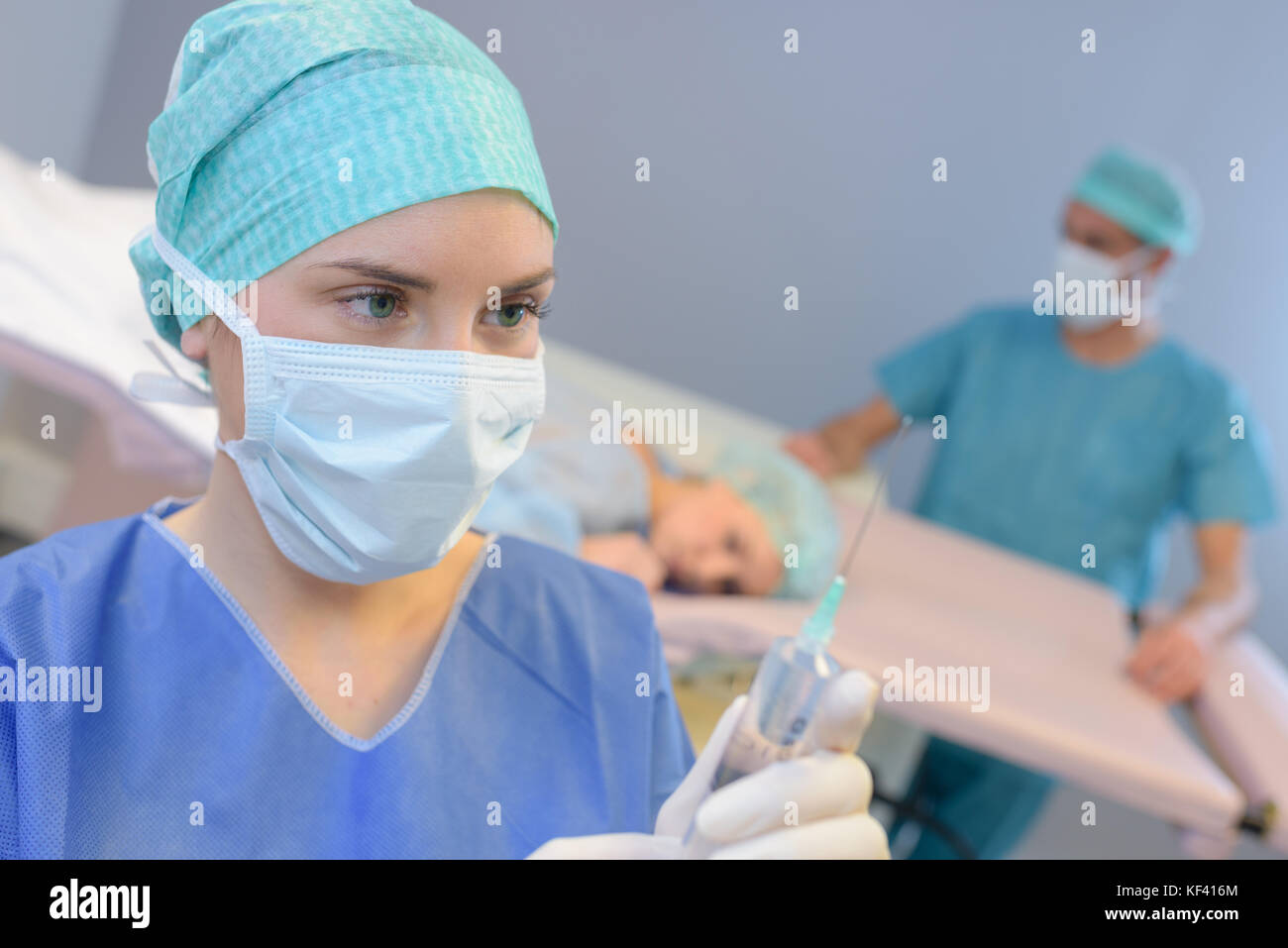 surgeon holding an injection needle Stock Photo - Alamy