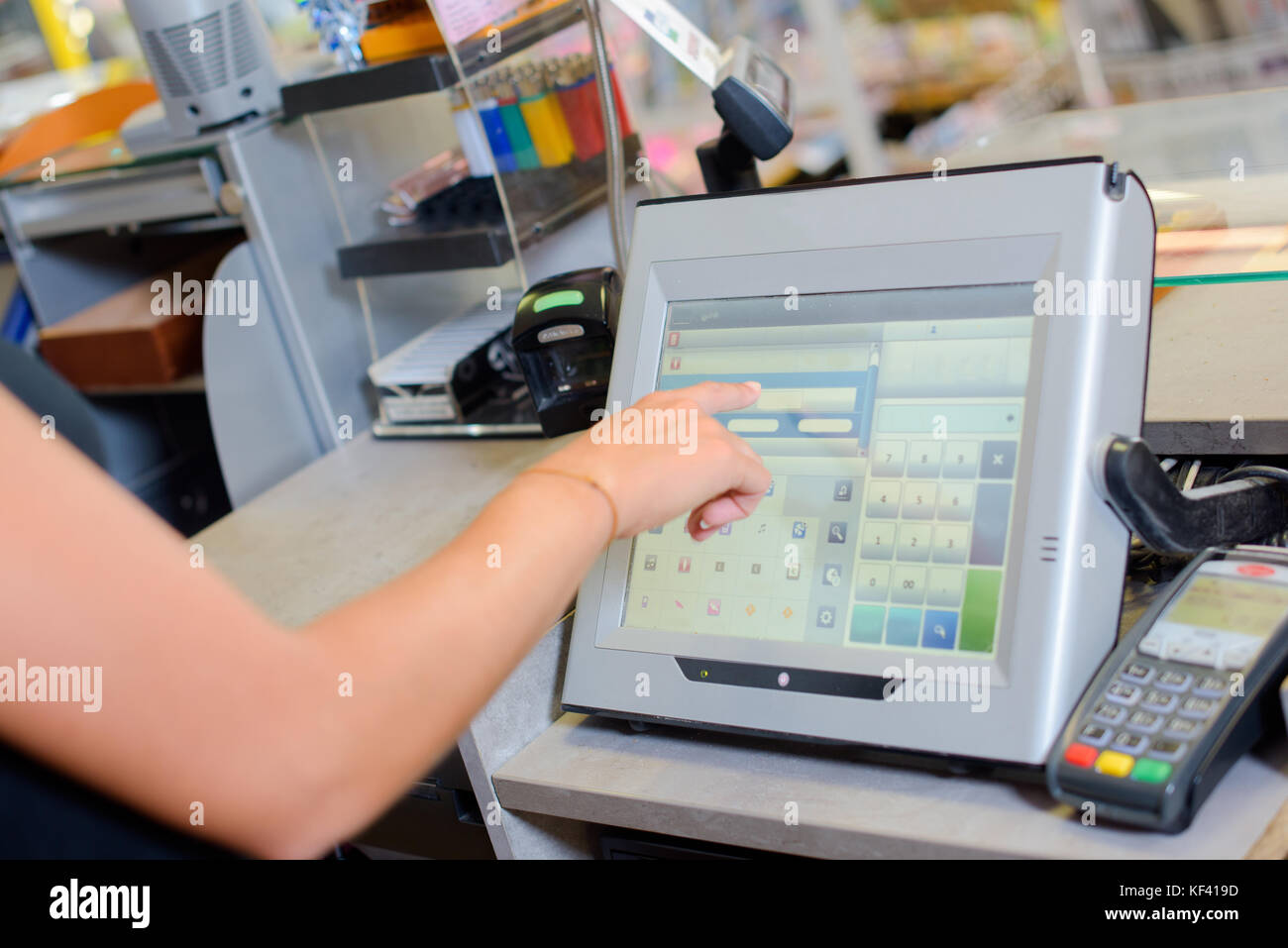 Young female cashier selling hi-res stock photography and images - Alamy