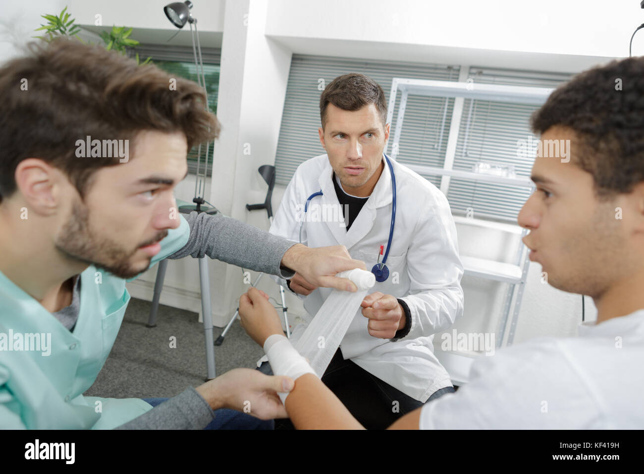 nurse putting bandage around the arm Stock Photo - Alamy