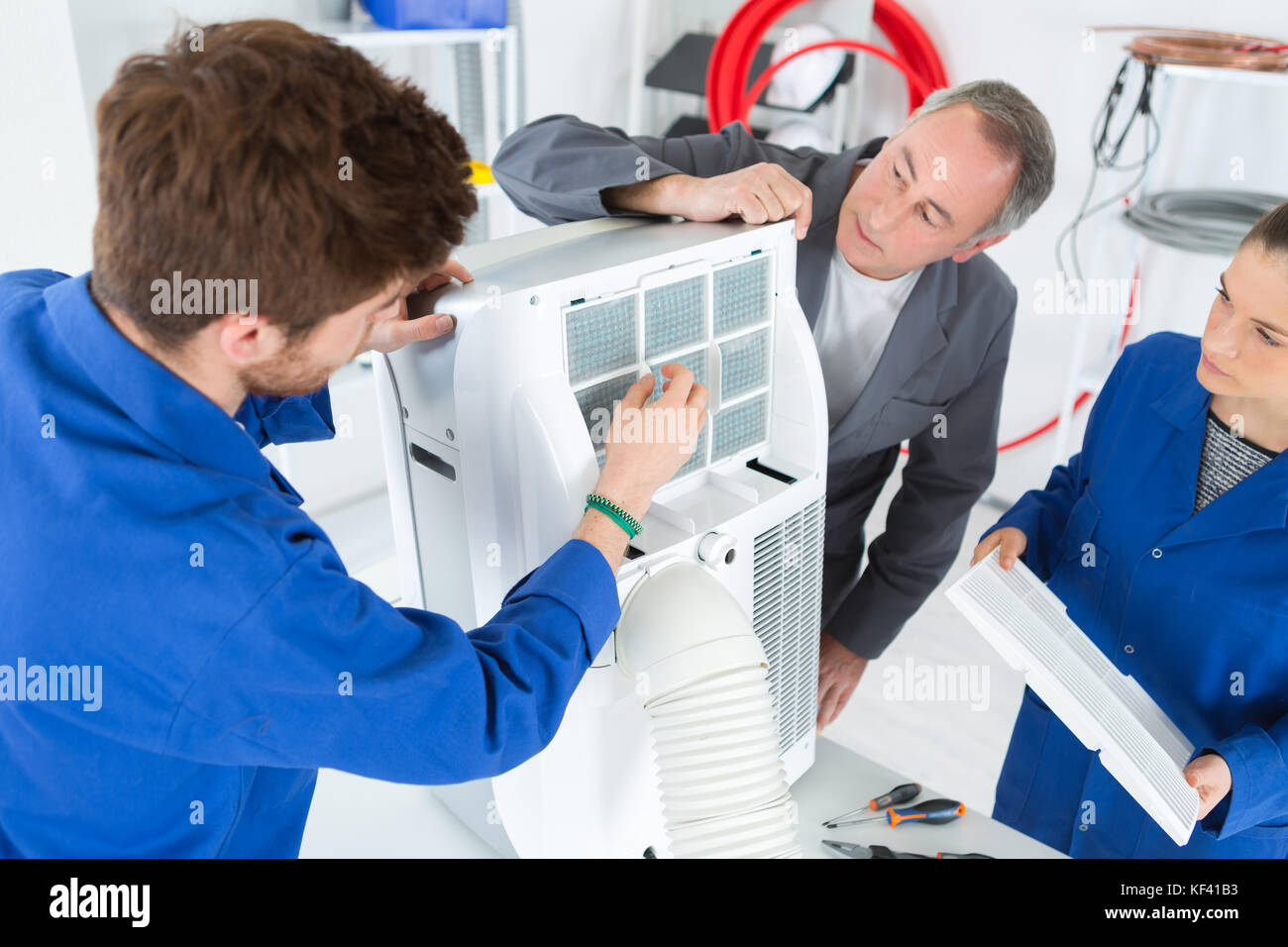 apprentice assembling an appliance Stock Photo - Alamy