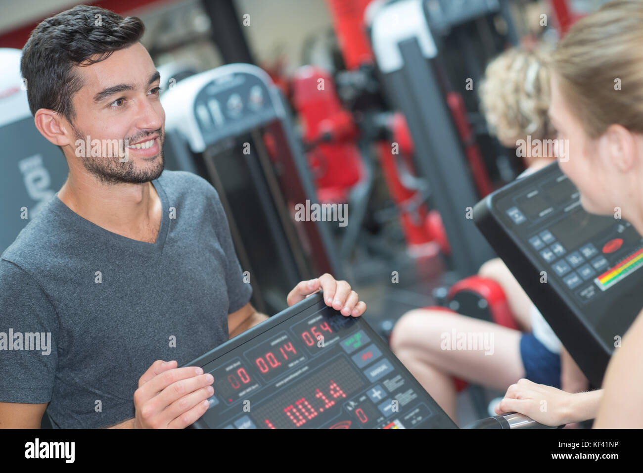trainer inspecting the gym member performance Stock Photo - Alamy