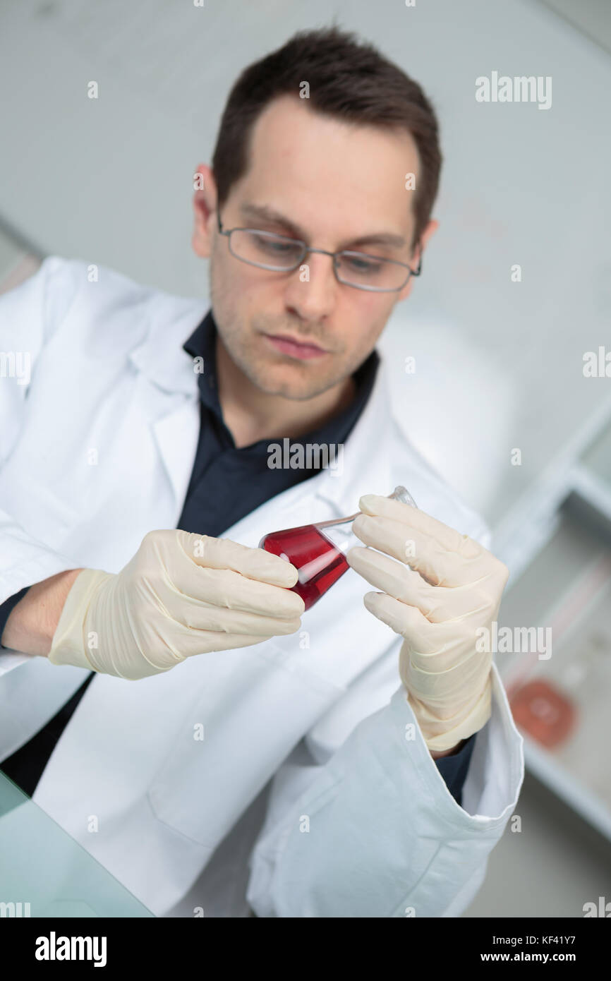 scientist mixing solution Stock Photo - Alamy
