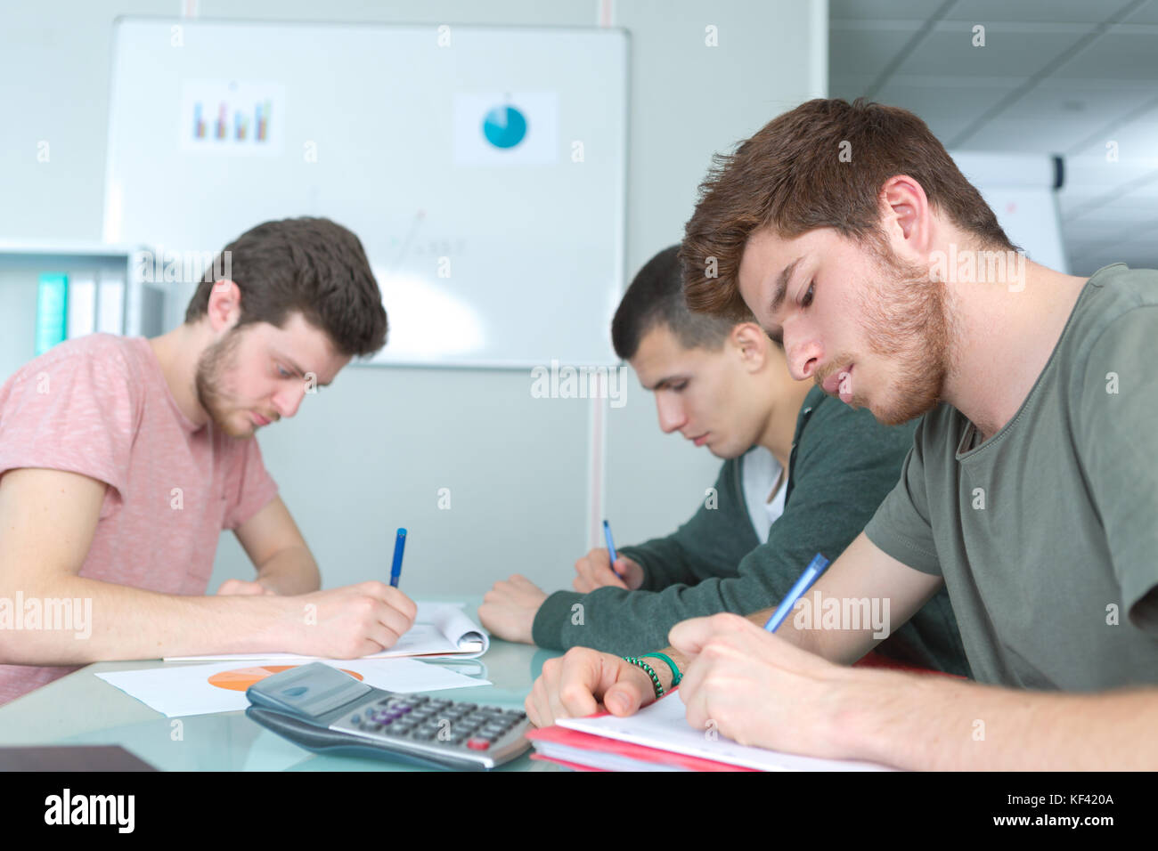 students writing something during conference Stock Photo - Alamy