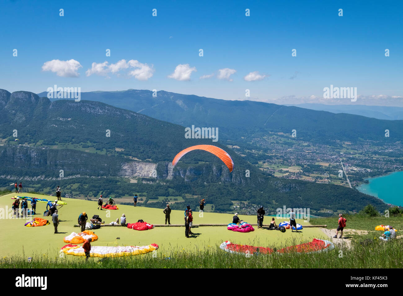 Paragliders preparing and launching from the Col de la Forclaz above ...