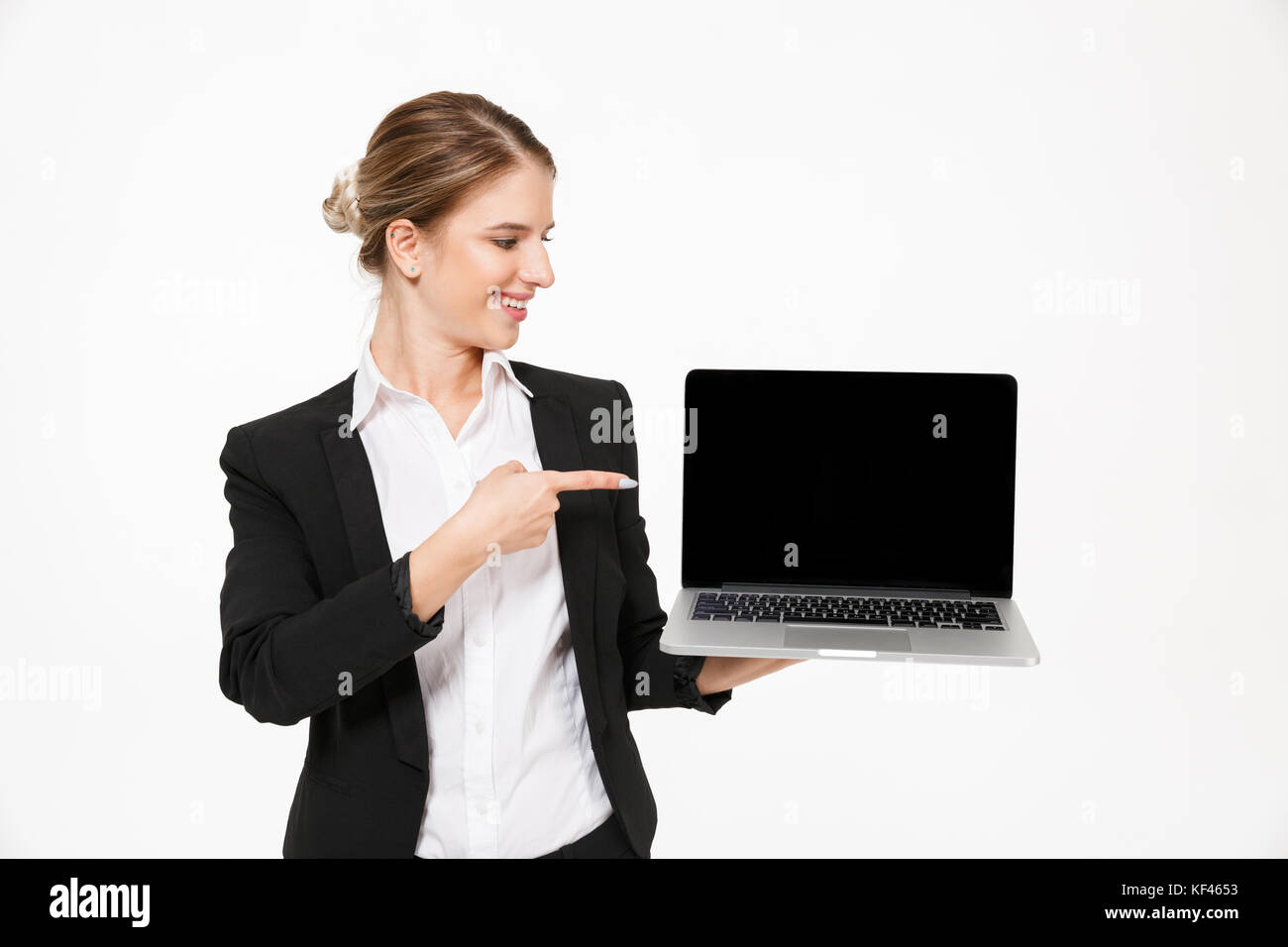 Happy blonde business woman showing blank laptop computer screen while ...