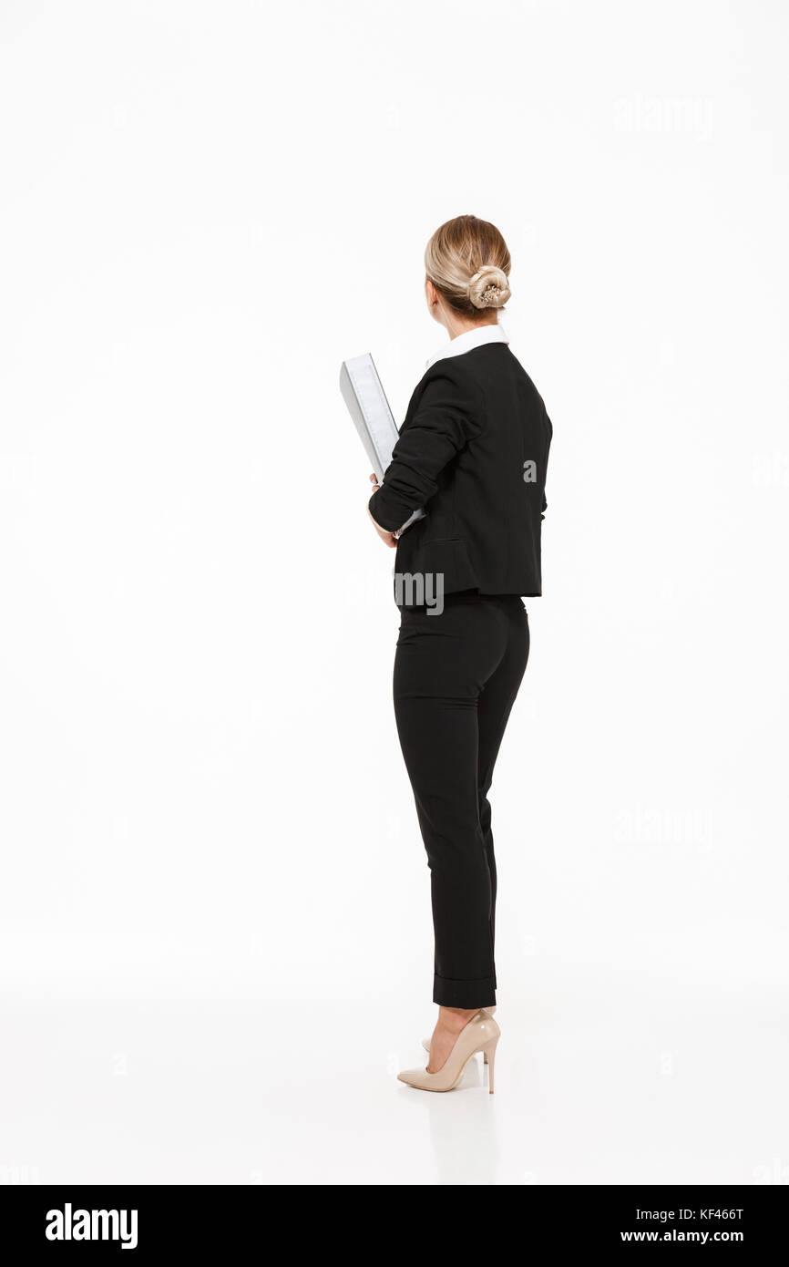 Vertical back view of blonde business woman holding big folder over ...