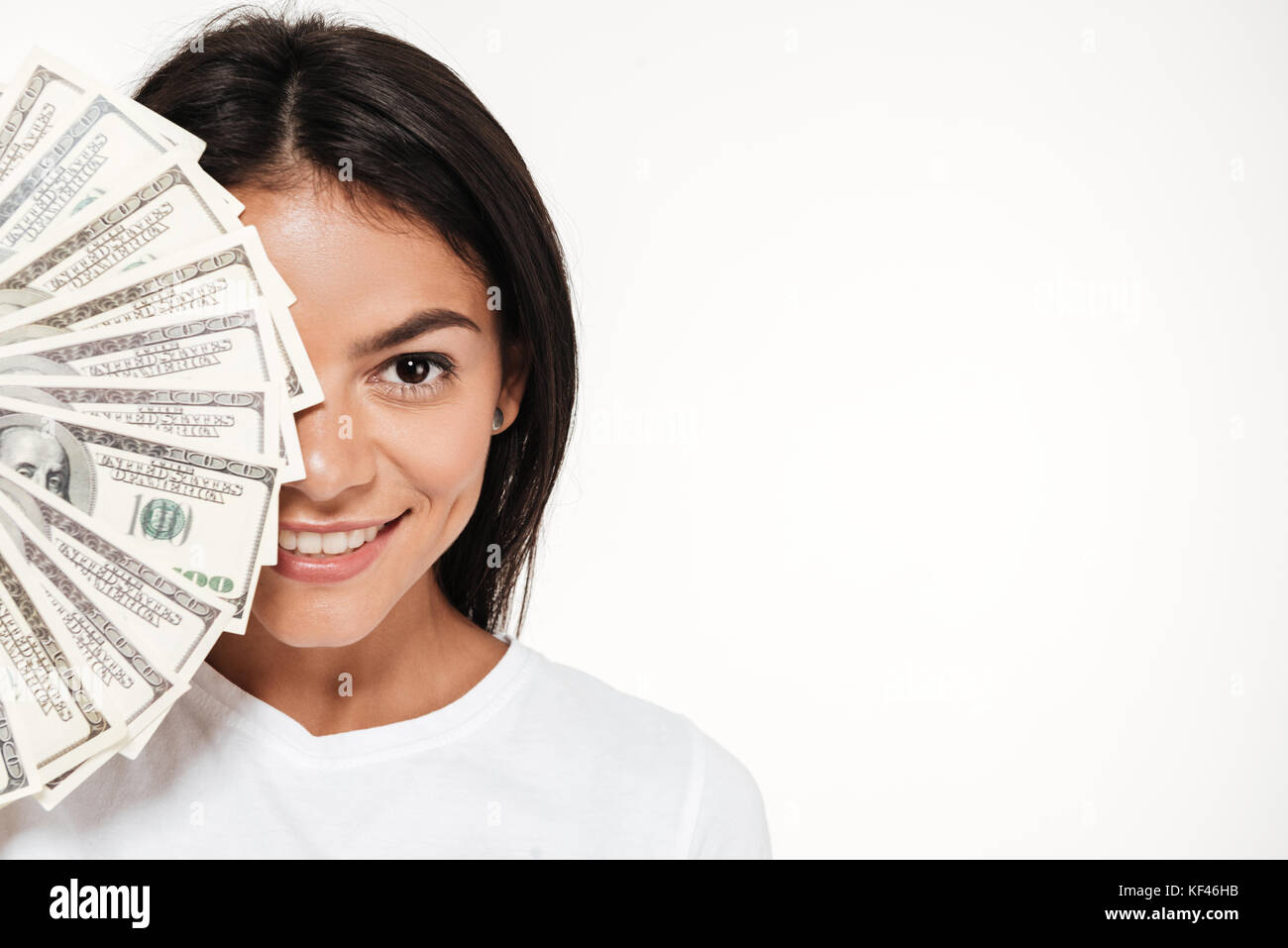 Close up portrait of a smiling attractive woman showing bunch of money ...