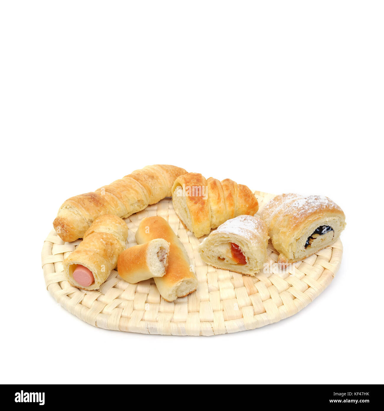 variety assortment of baked filled pastry on wicker rattan coaster ...