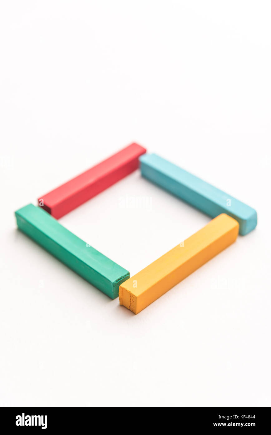 Close up of colorful pastel crayons, laid out in square, over white ...