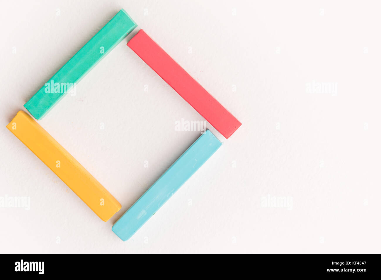 Close up of colorful pastel crayons, laid out in square, over white ...