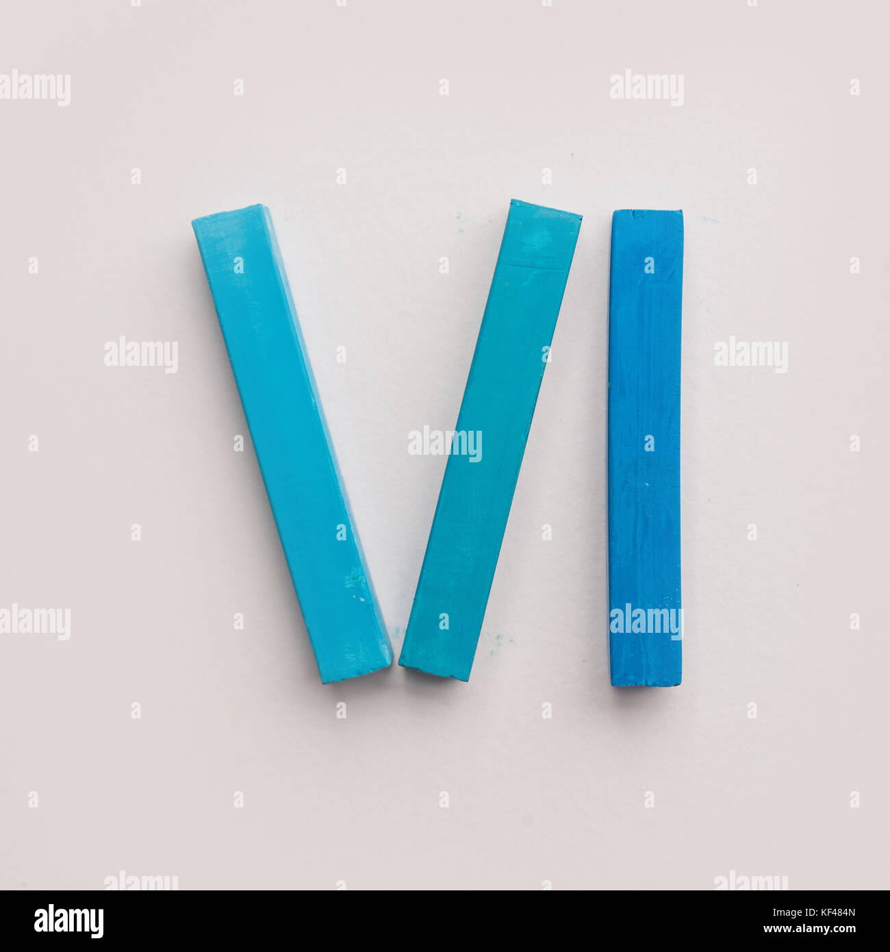 Six pieces of blue pastel crayon chalks isolated over white background ...