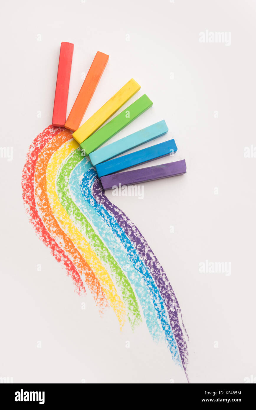 Rainbow gradient made of pastel crayon chalks over the colorful traces ...