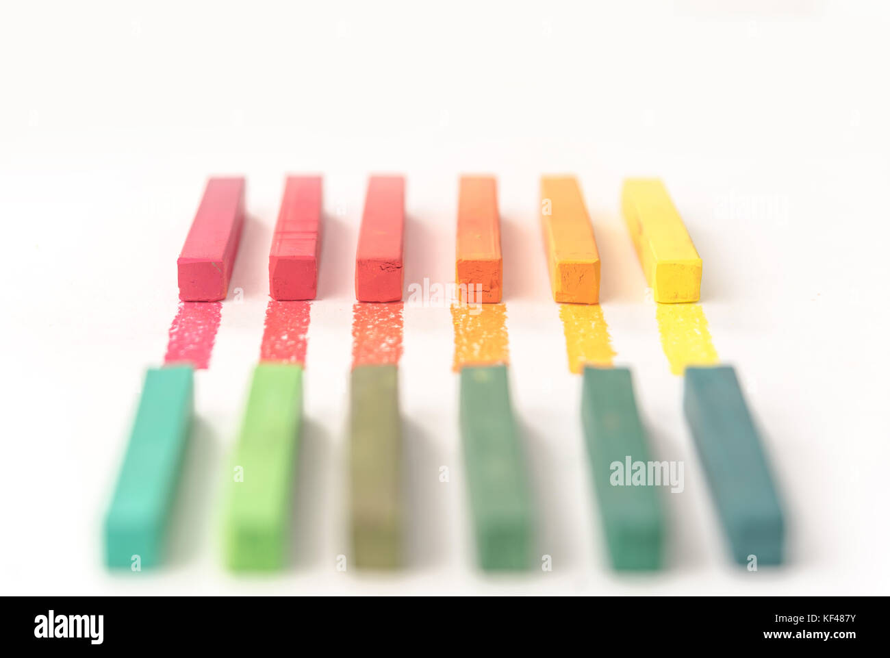 Close up of colorful pastel chalks and their pigments on white ...