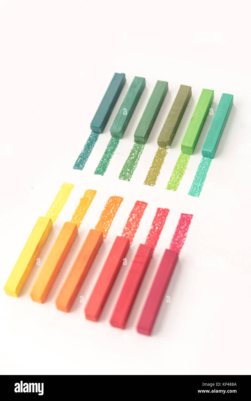 Close up view of colorful pastel chalks and their pigments on white ...