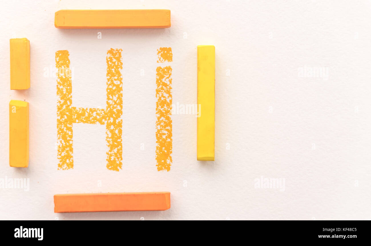 Top view of word Hi drawn with orange pastel chalk, over white paper ...