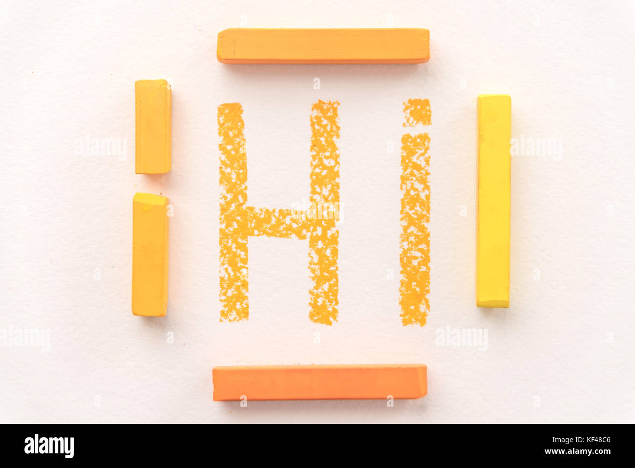 Top view of word Hi drawn with orange pastel chalk, over white paper ...
