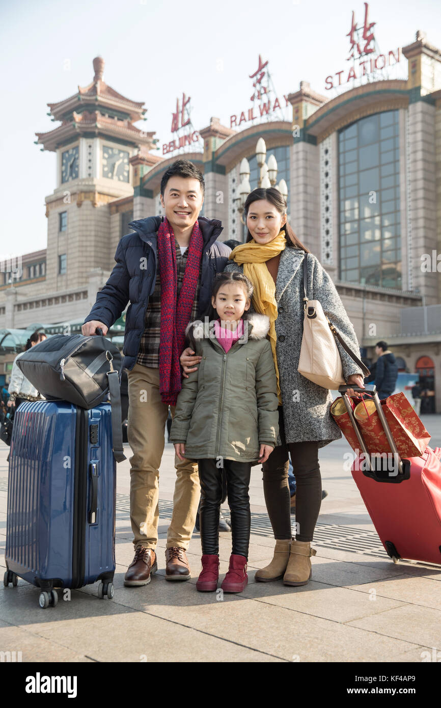Happy family at the railway station Stock Photo - Alamy