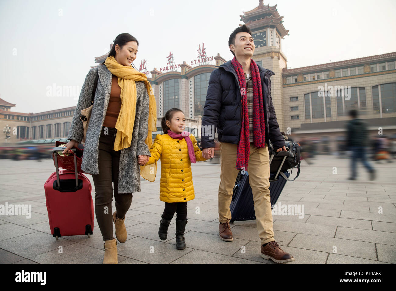 Happy family at the railway station Stock Photo - Alamy