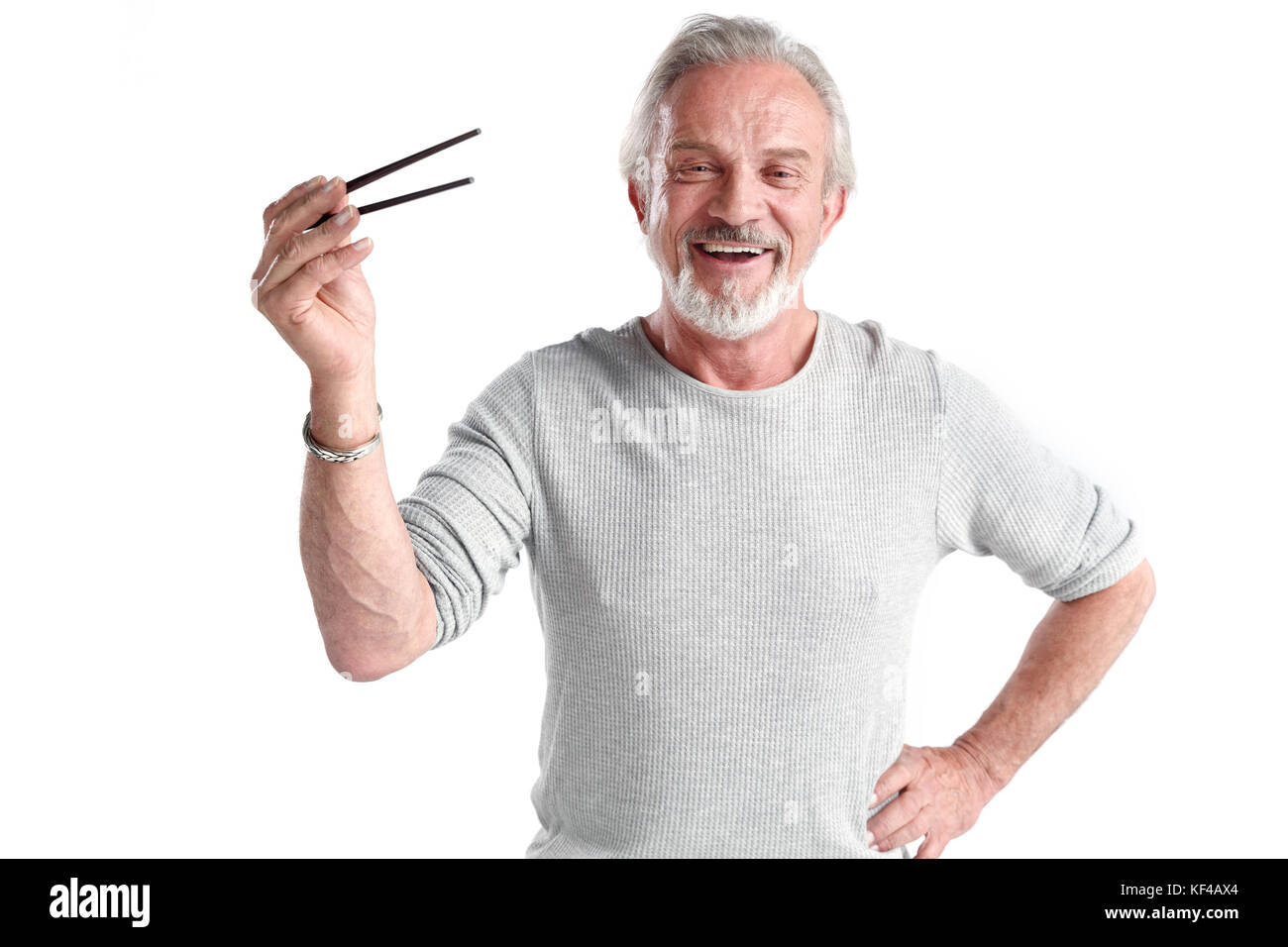 Old man holding chopsticks Stock Photo - Alamy