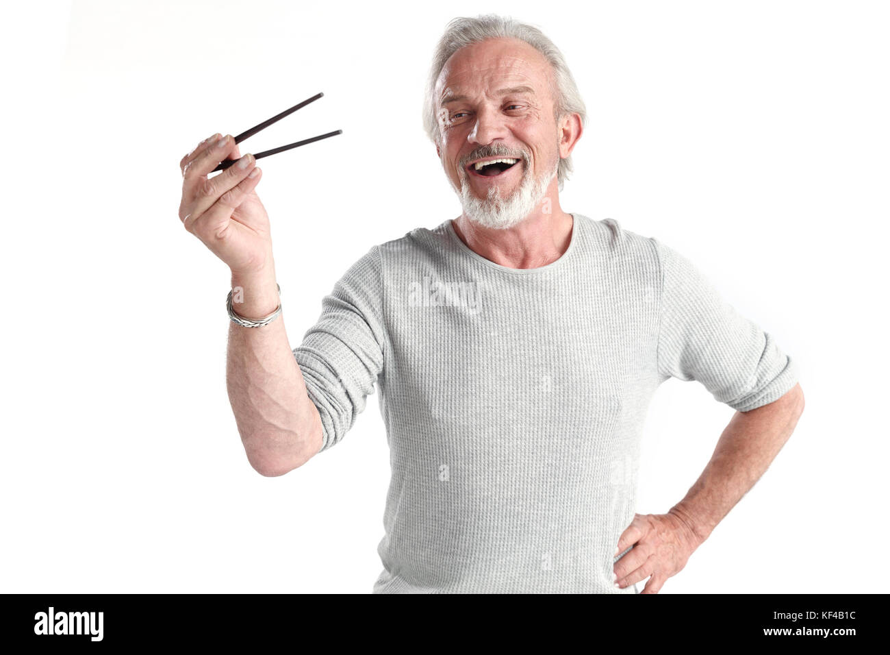 Old man holding chopsticks Stock Photo - Alamy