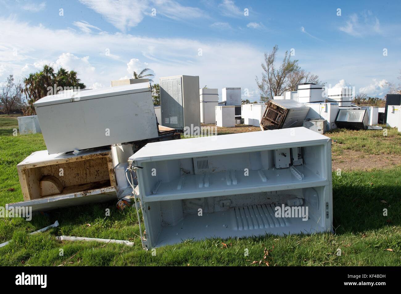Damaged refrigerators and debris wait for trash collection after ...