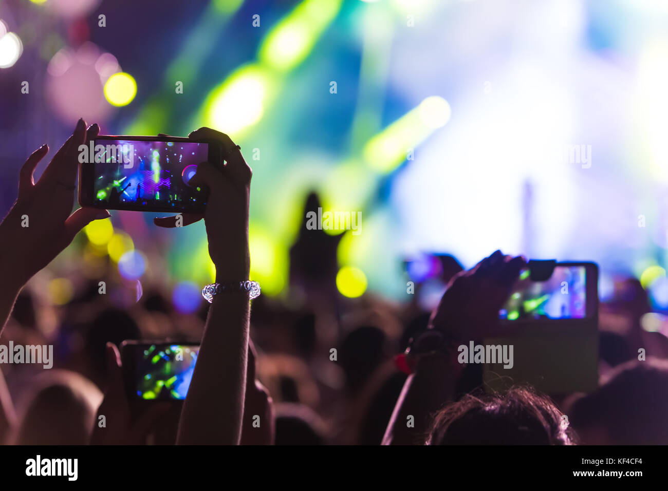 Hand with a smartphone records live music festival, Taking photo of ...