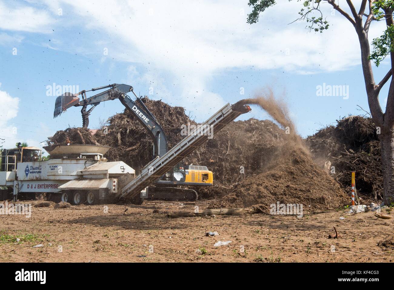Construction workers grind debris into fine dirt in the aftermath of ...