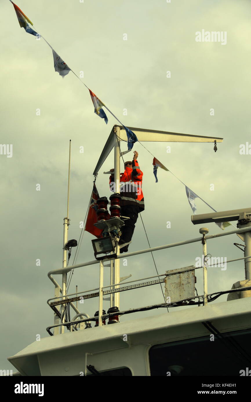 Ferry crew member working on mast Stock Photo - Alamy