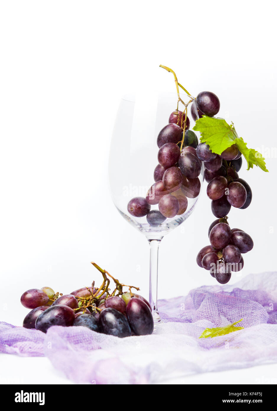 Fresh red grape in wine glass on white Stock Photo - Alamy
