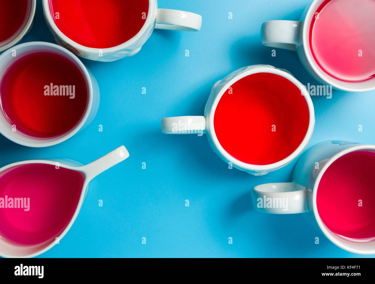 Red herbal tea in cups on blue background top view Stock Photo - Alamy