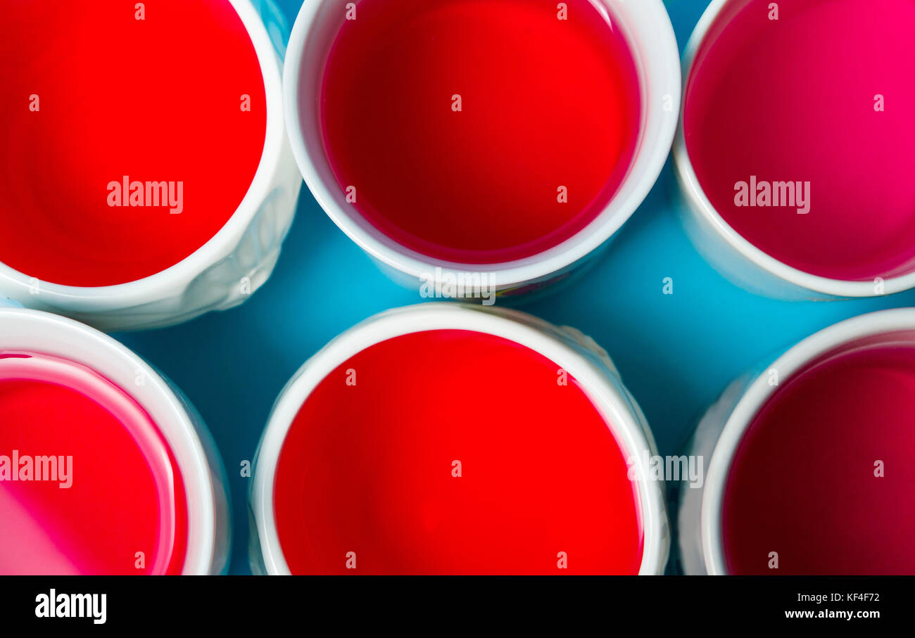Red herbal tea in cups on blue background top view Stock Photo - Alamy