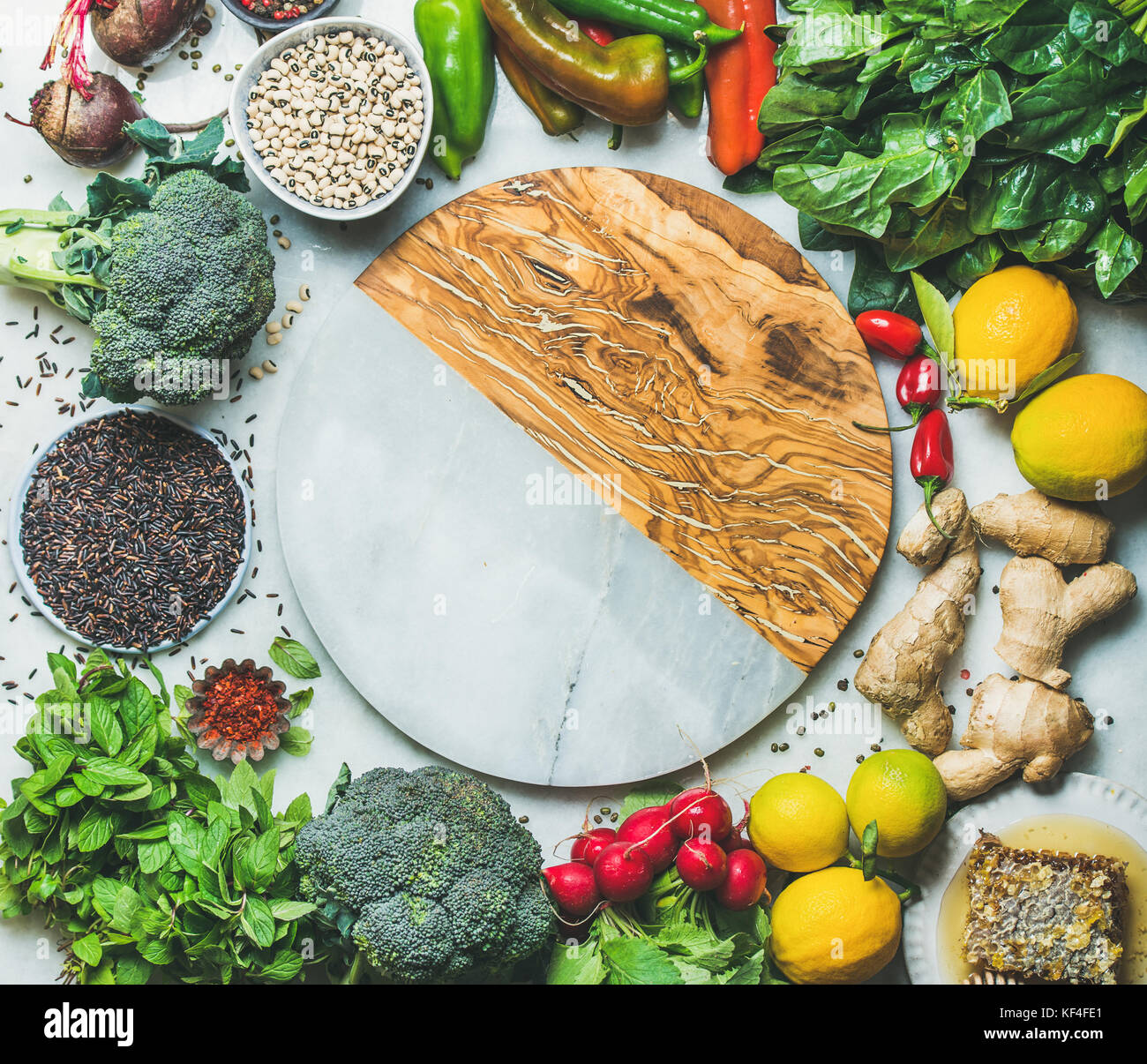 Clean eating healthy cooking ingredients with round board in center ...