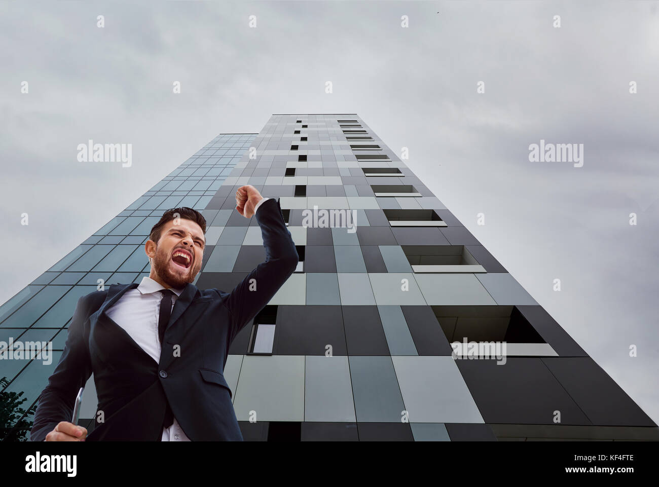 A businessman screaming raising his hand up against a business b Stock ...