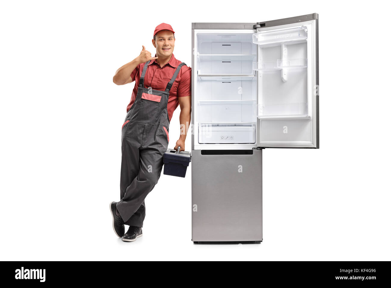 Full length portrait of a serviceman leaning against an empty fridge ...