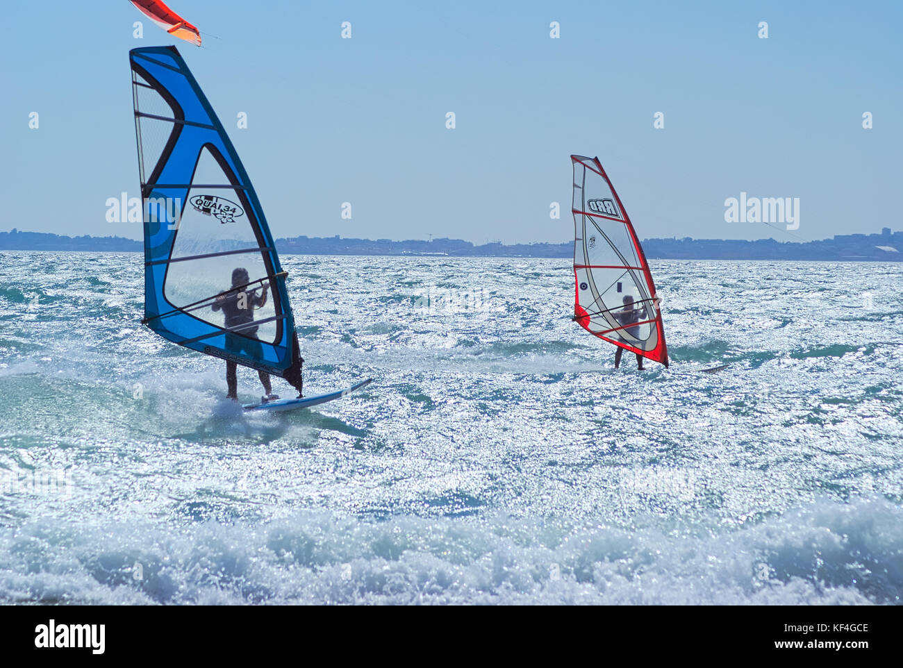 Two Windboarders at full speed during a windy day in Mediterranean sea ...