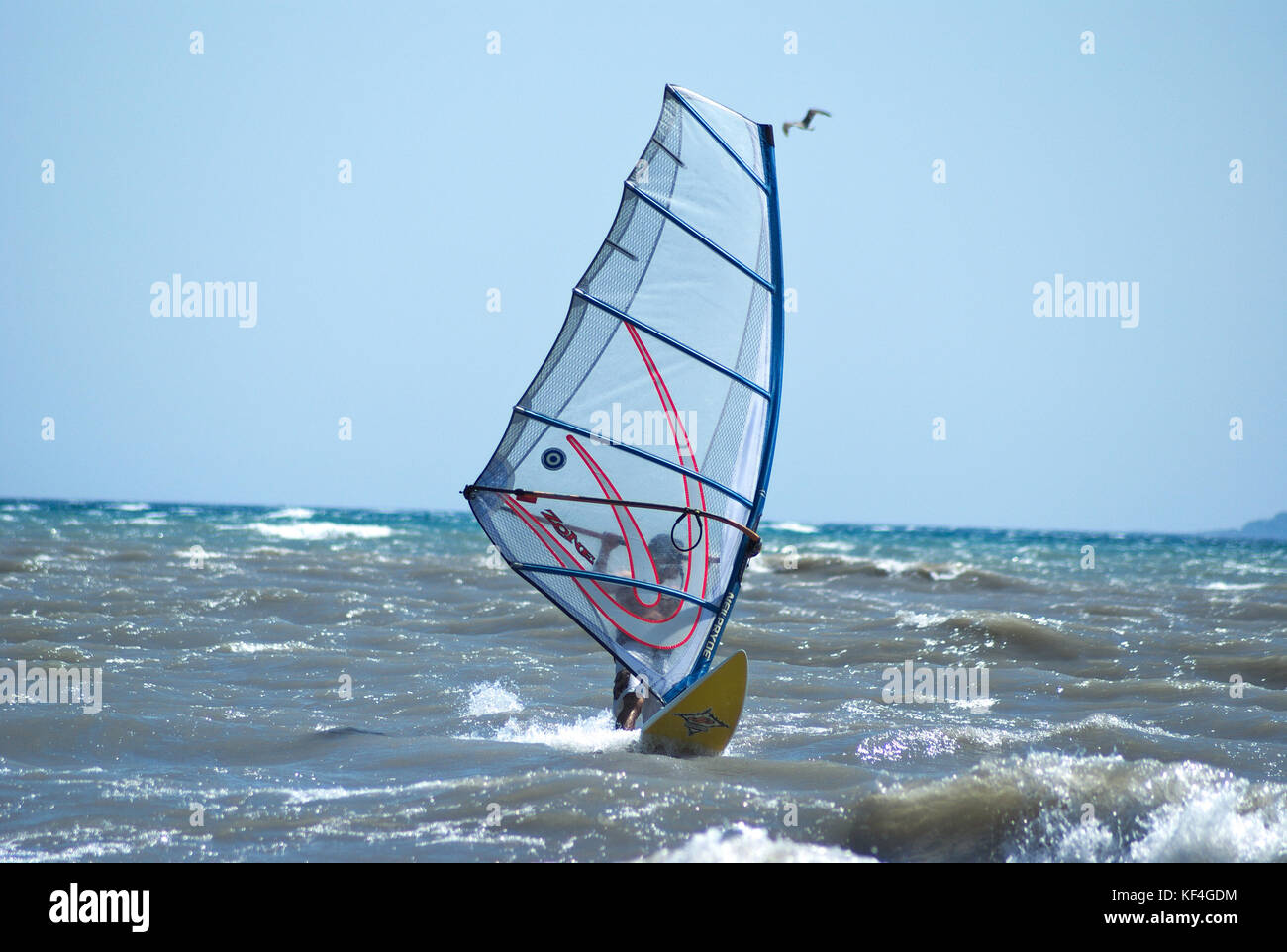 Windboarder reaching downwind during a windy day in Mediterranean sea ...