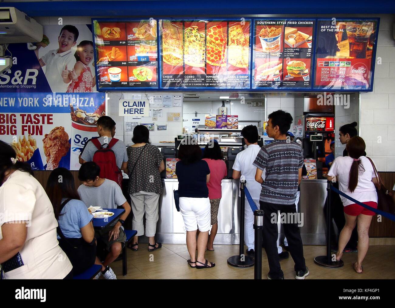 ANTIPOLO CITY, PHILIPPINES - OCTOBER 19, 2017: Customers line up at the ...
