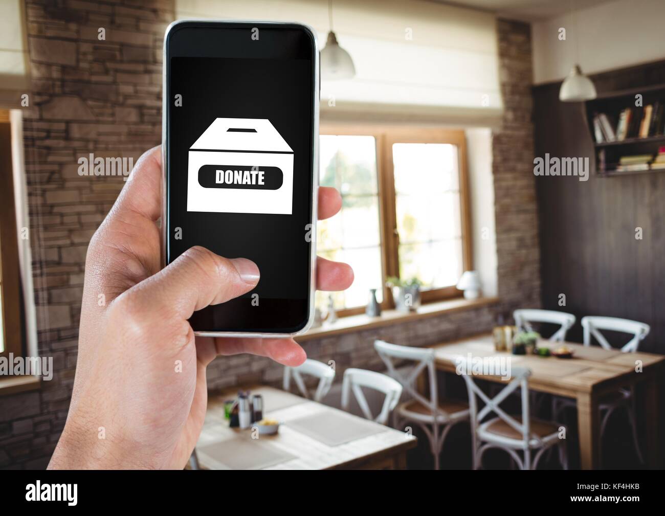 Hand holding phone donate hi-res stock photography and images - Alamy