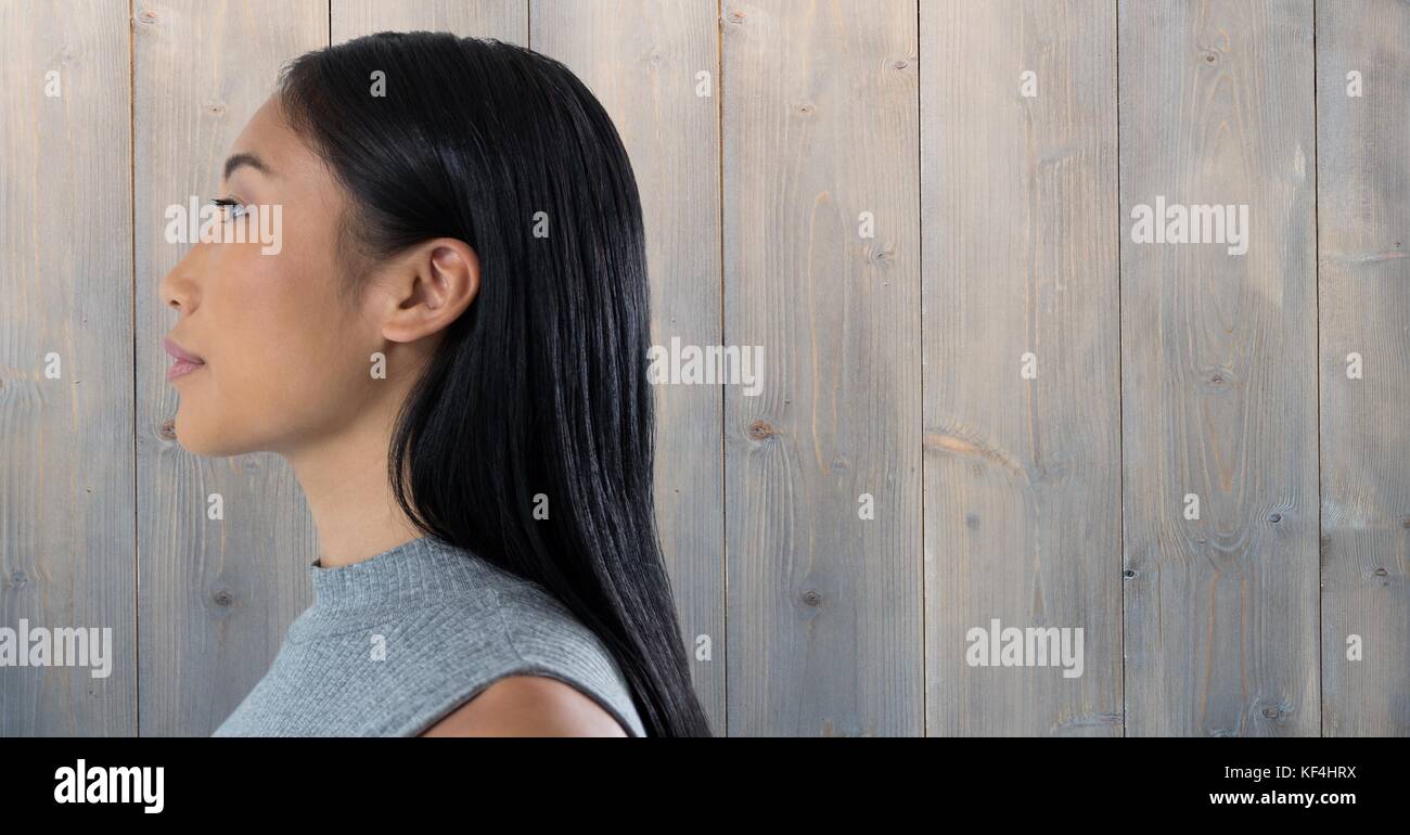 Digital composite of Woman looking forward with wooden background Stock ...