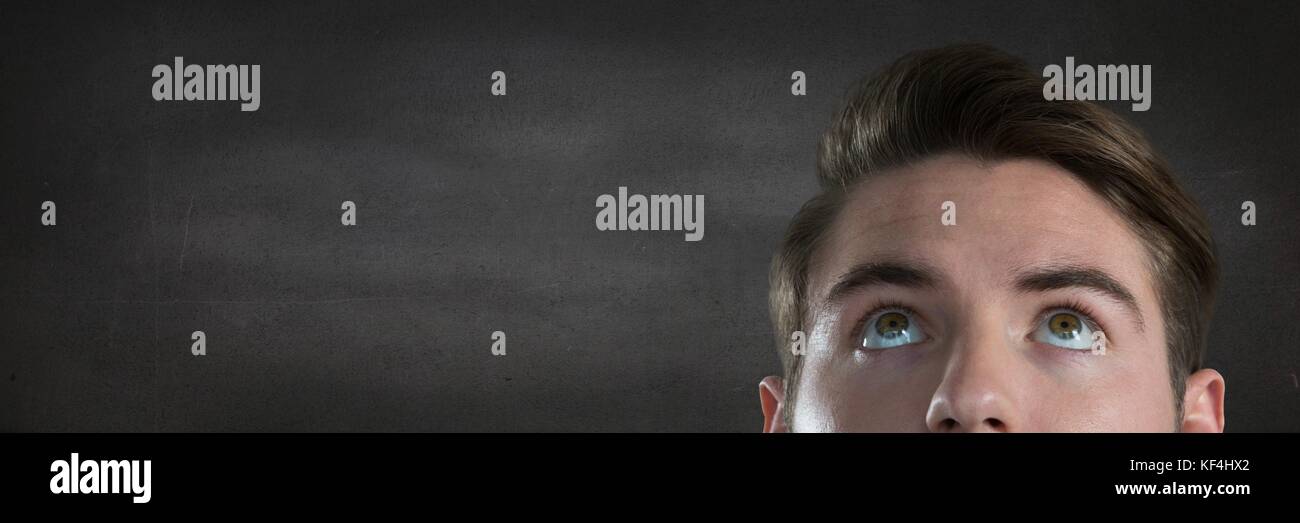 Digital composite of Man looking up with dark stone background Stock ...