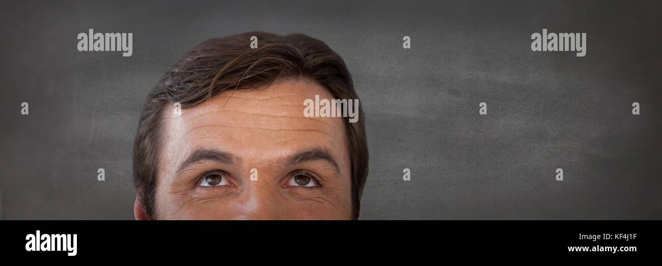 Digital composite of Man looking up with dark stone background Stock ...