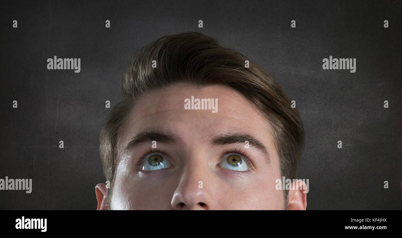 Digital composite of Man looking up with dark stone background Stock ...