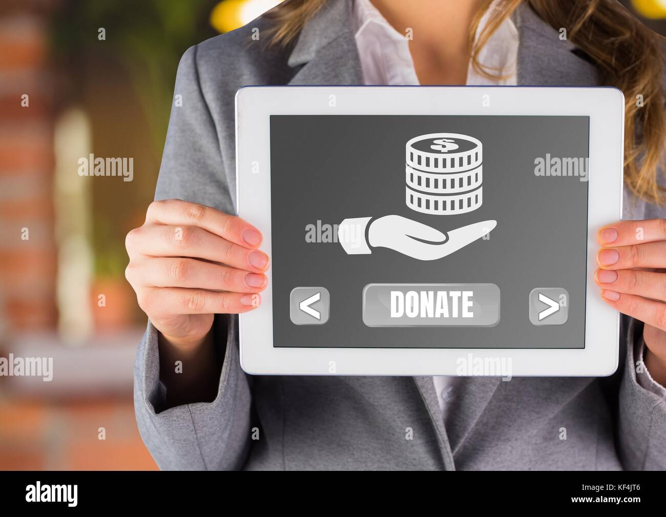 Digital composite of Hand holding tablet with donate button and hand ...