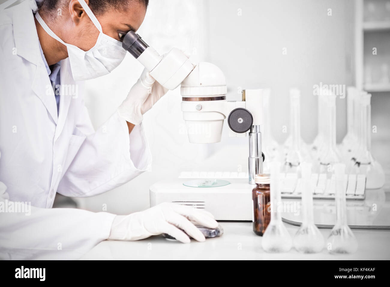 Scientist working on microscope in laboratory Stock Photo - Alamy