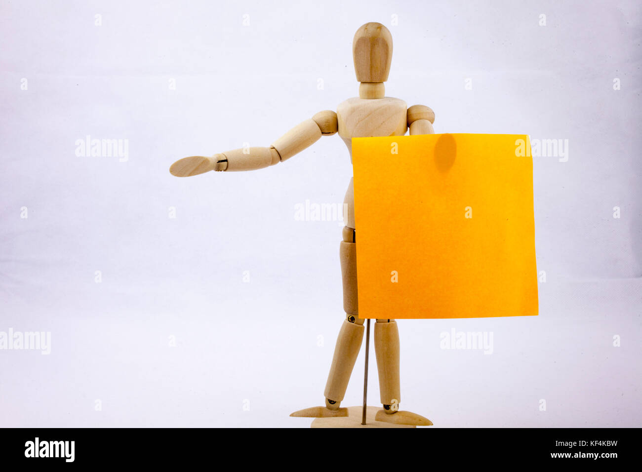 orange sticky note reminders on a white background with wooden ...
