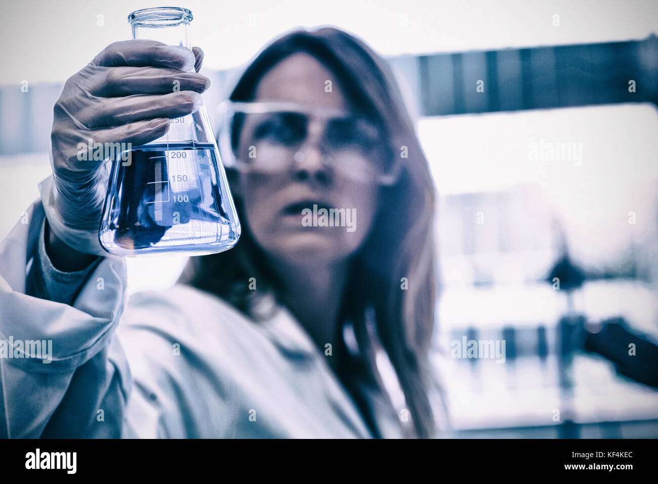 Chemist holding up beaker hi-res stock photography and images - Alamy