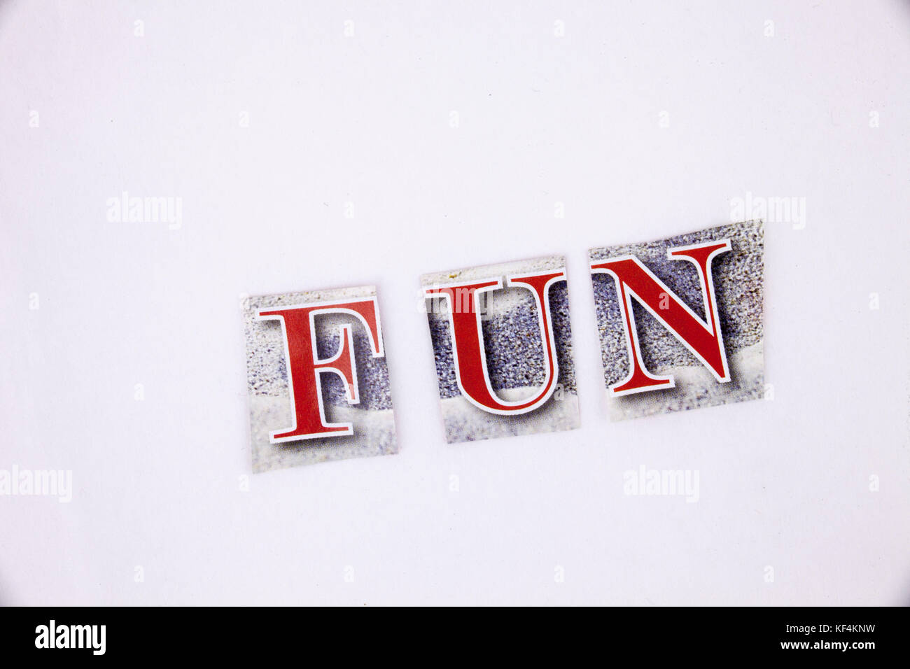 A word writing text showing concept of FUN made of different magazine ...